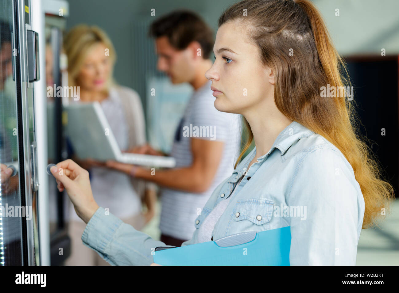 woman pushing button on vending machine Stock Photo - Alamy
