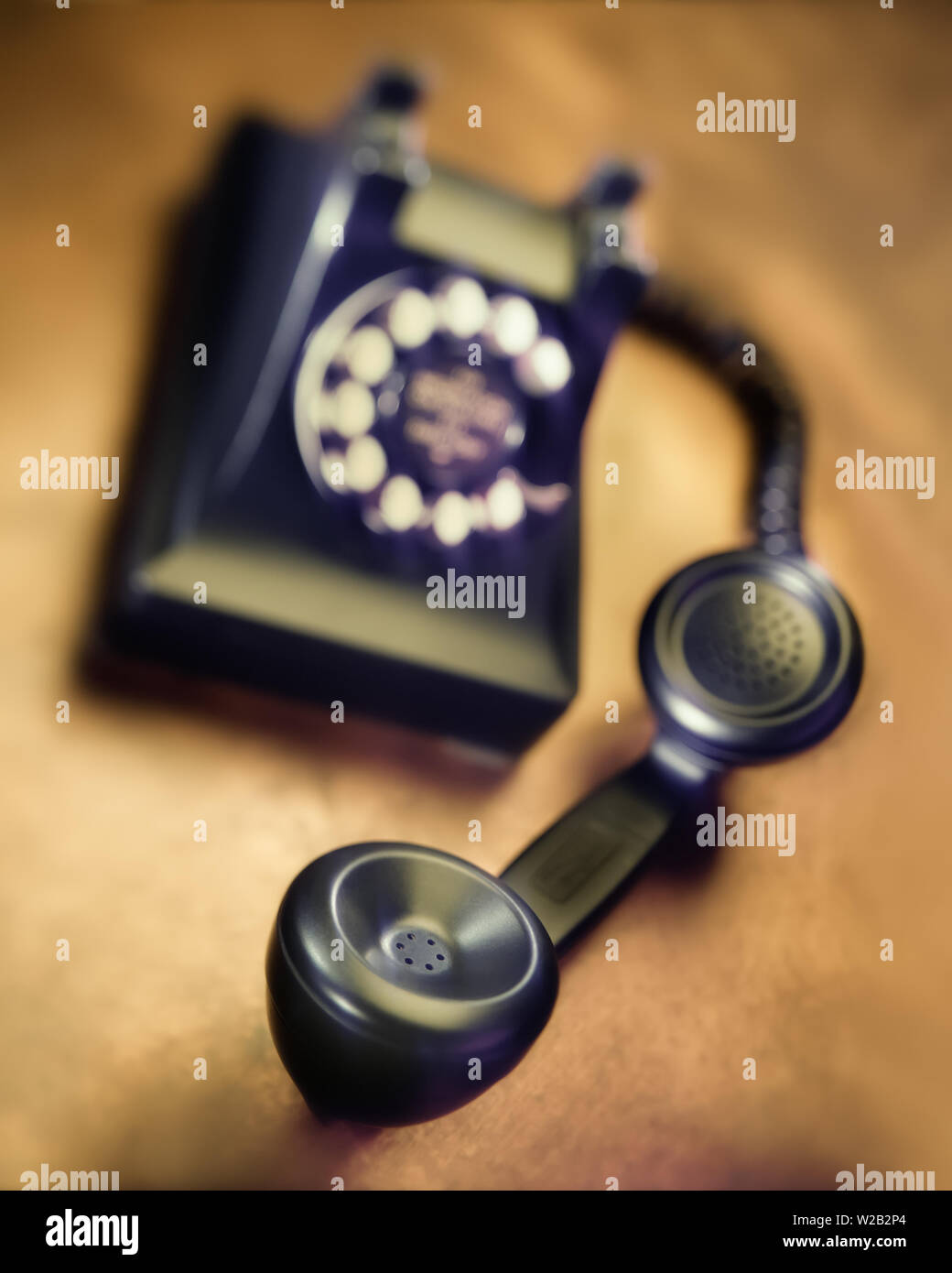 Old black bakelite dial telephone on rustic metal surface. Selective ...