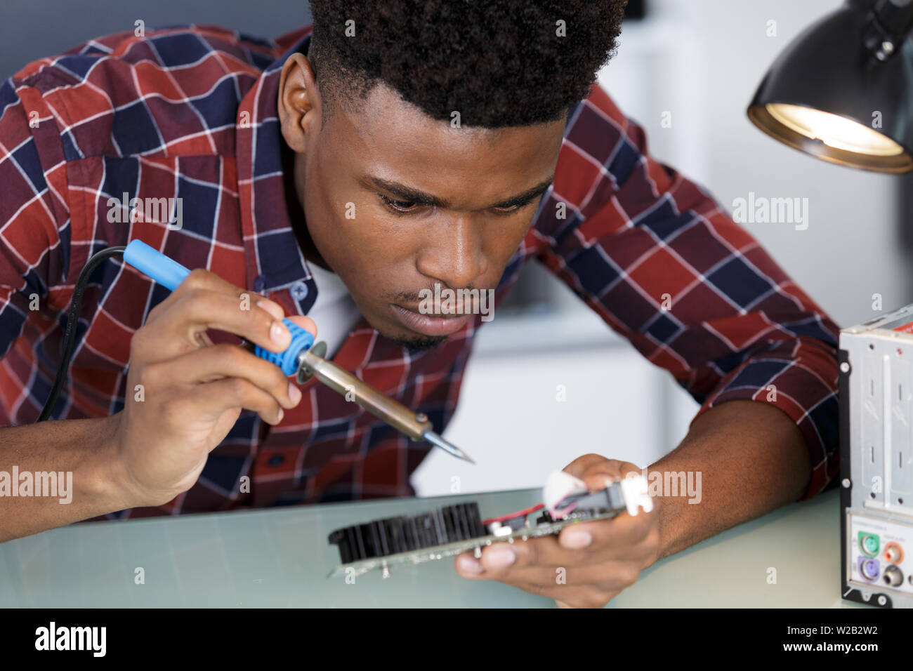 concentrated male worker soldering mainboard Stock Photo - Alamy