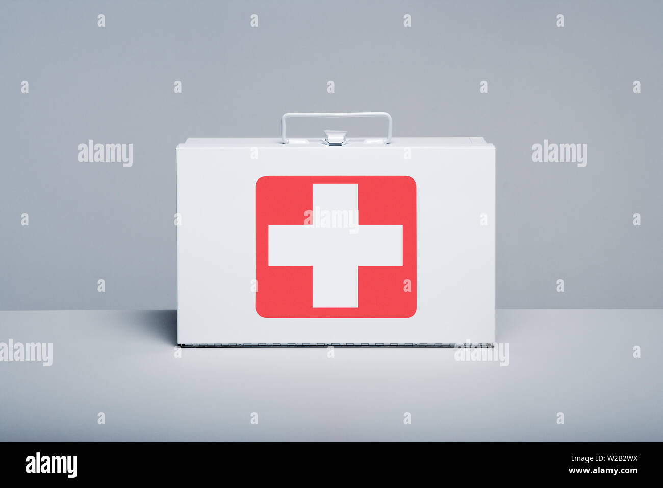 Tin first aid kit with cross emblem on grey background Stock Photo - Alamy
