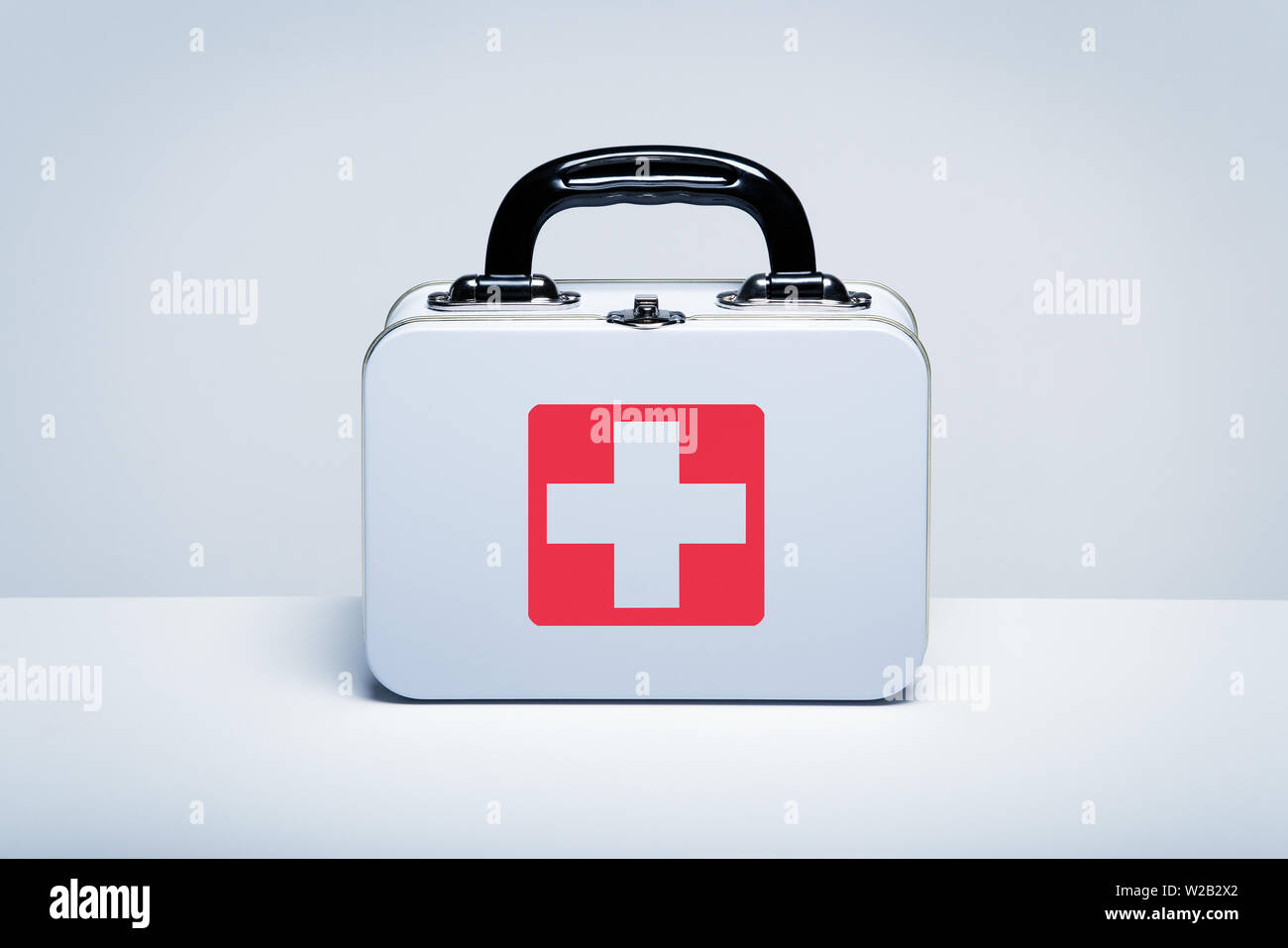 Tin first aid kit with cross emblem on grey background Stock Photo - Alamy