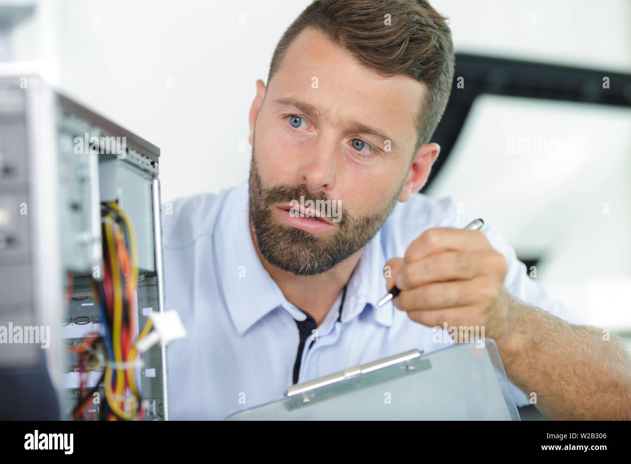male worker fixing a machine Stock Photo - Alamy