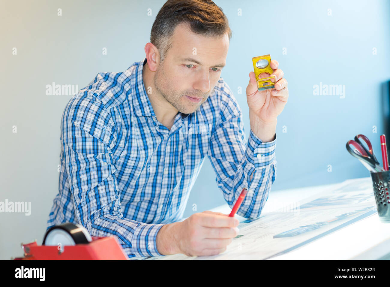 young creative male engineer making project on drawing board Stock ...