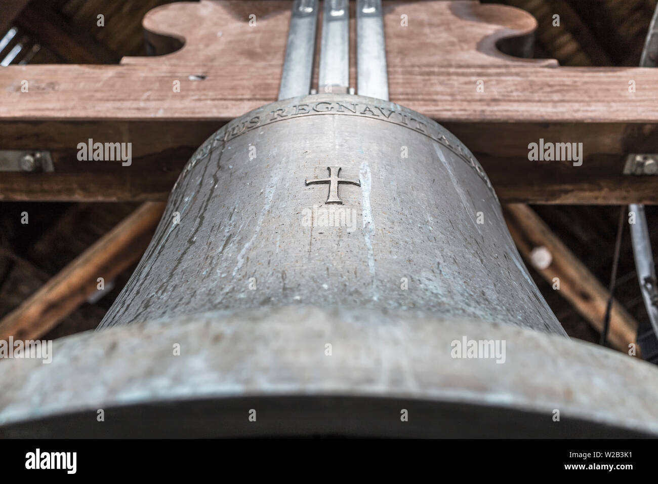 The big church bell with a cross on the body Stock Photo - Alamy