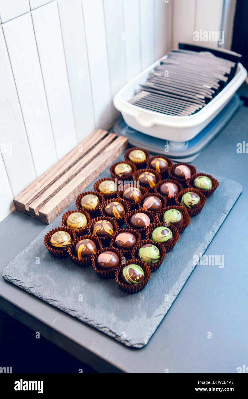 Many small colorful chocolate candies in individual paper wrapper lying ...