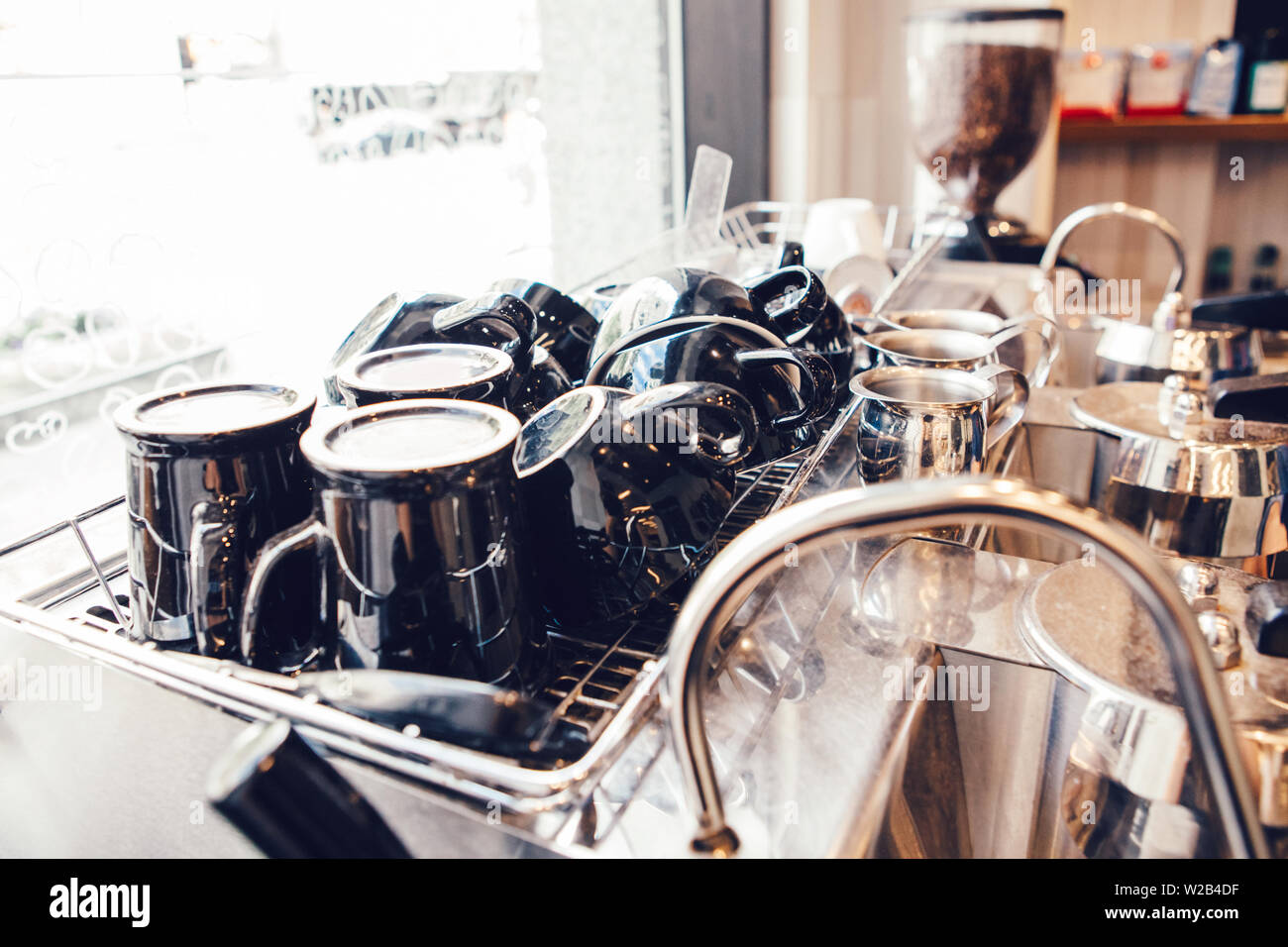 Black ceramic cups in coffee shop. Interior detail of local cafeteria ...
