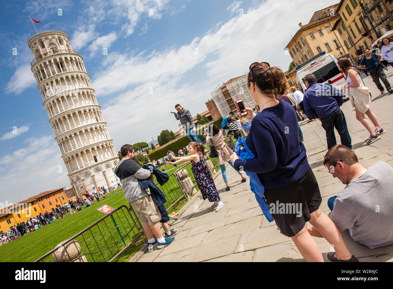 PISA, ITALY - APRIL, 2018: Tourists posing and taking pictures in front ...