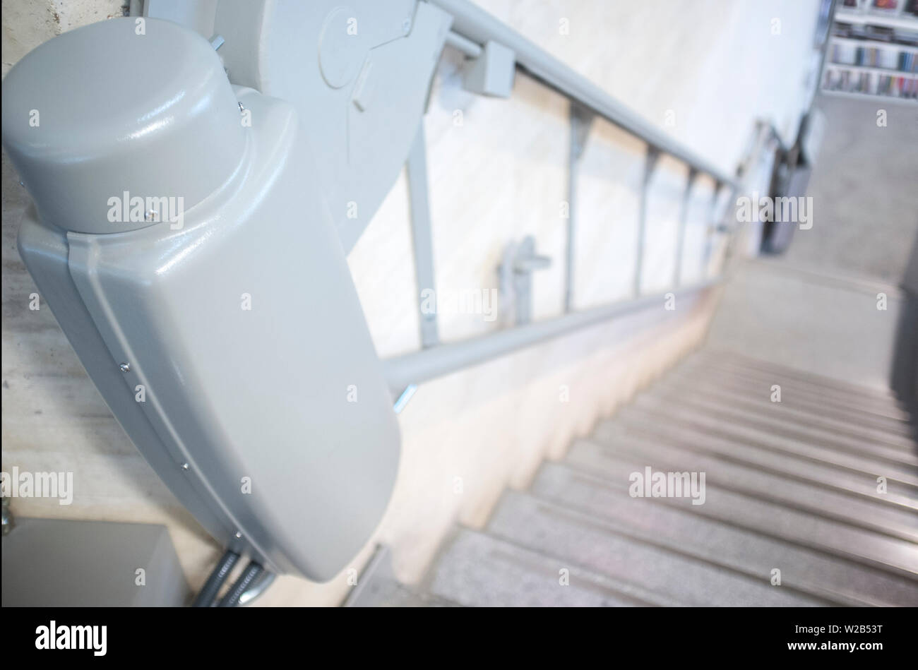 Chair lift for disabled and elderly people at library stairs. Libraries ...