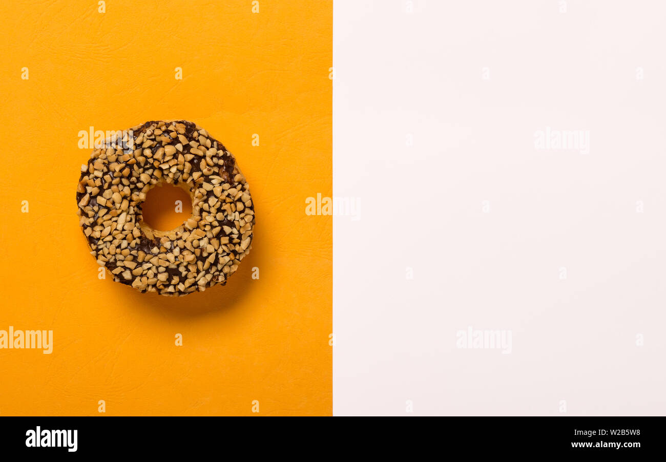 Doughnut with split color yellow and white background, close up food ...