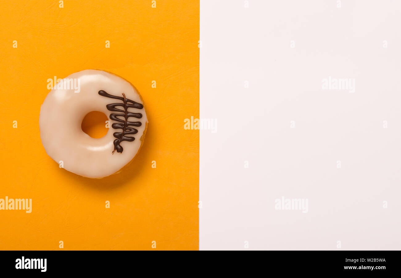 Doughnut with split color yellow and white background, close up food ...