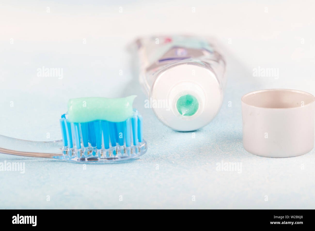 toothbrush on the table with toothpaste and toothpaste tube on blurred ...
