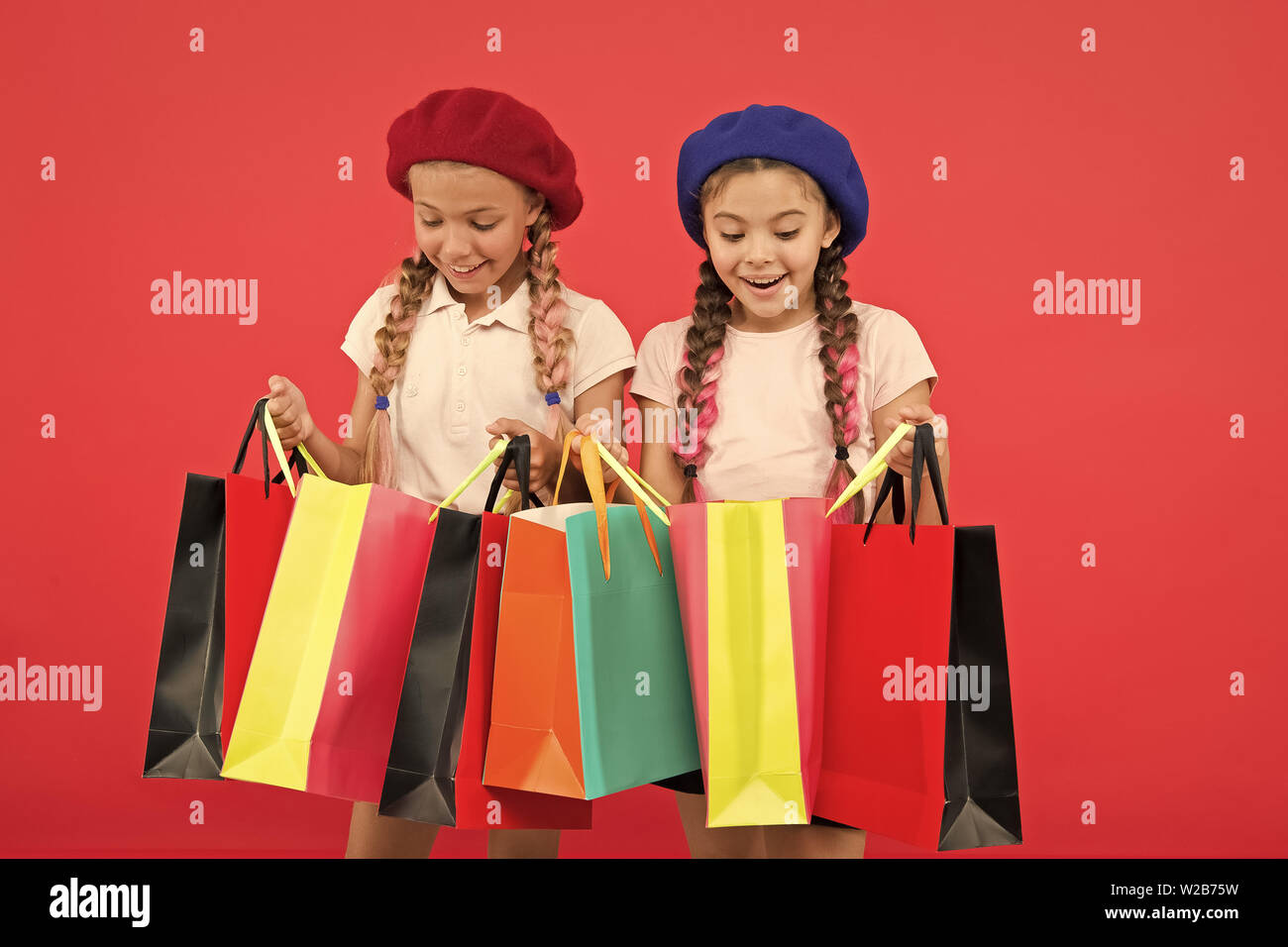 Children satisfied by shopping red background. Obsessed with shopping ...