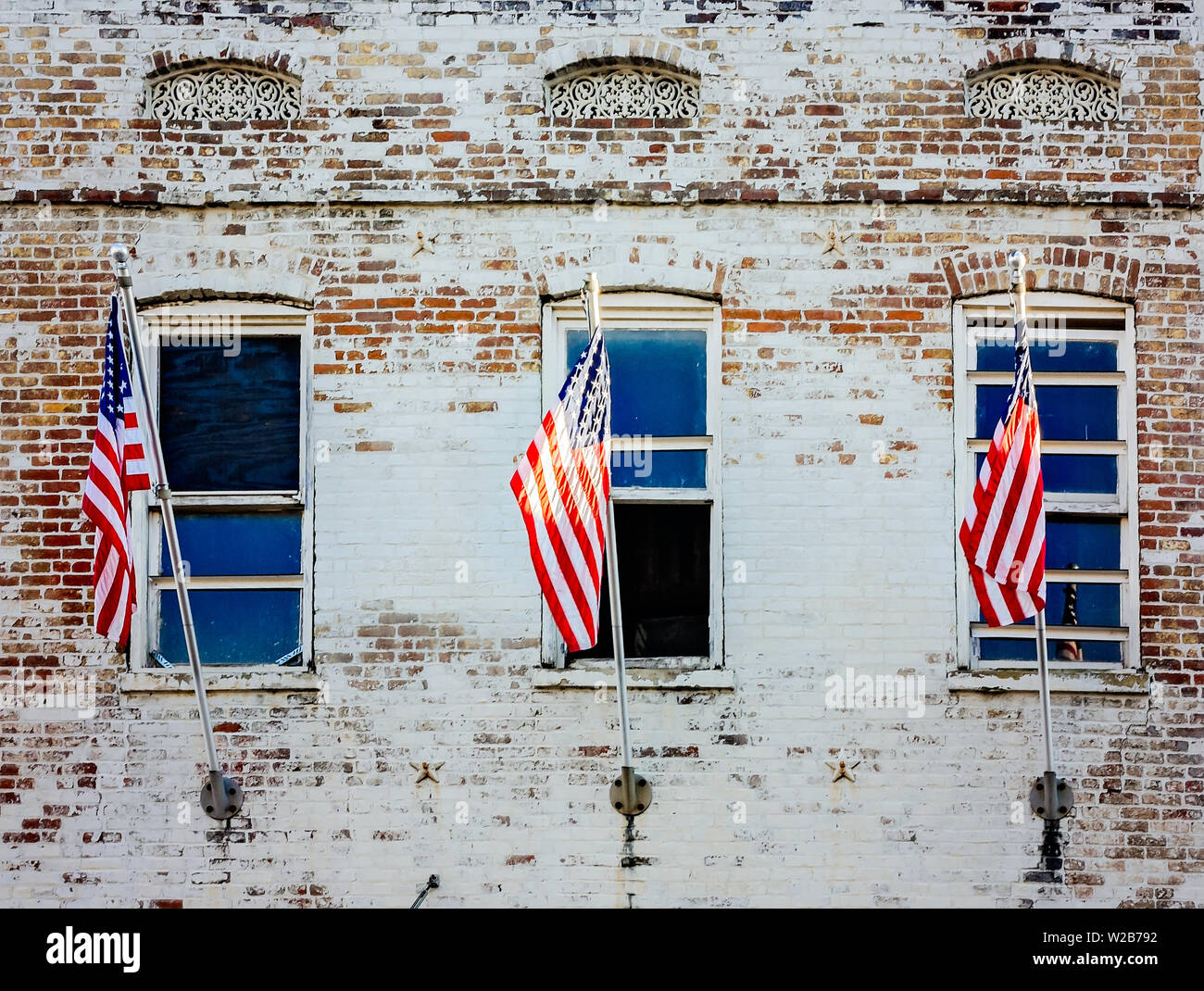 American flags hang from the windows of a historic building, Sept. 12 ...