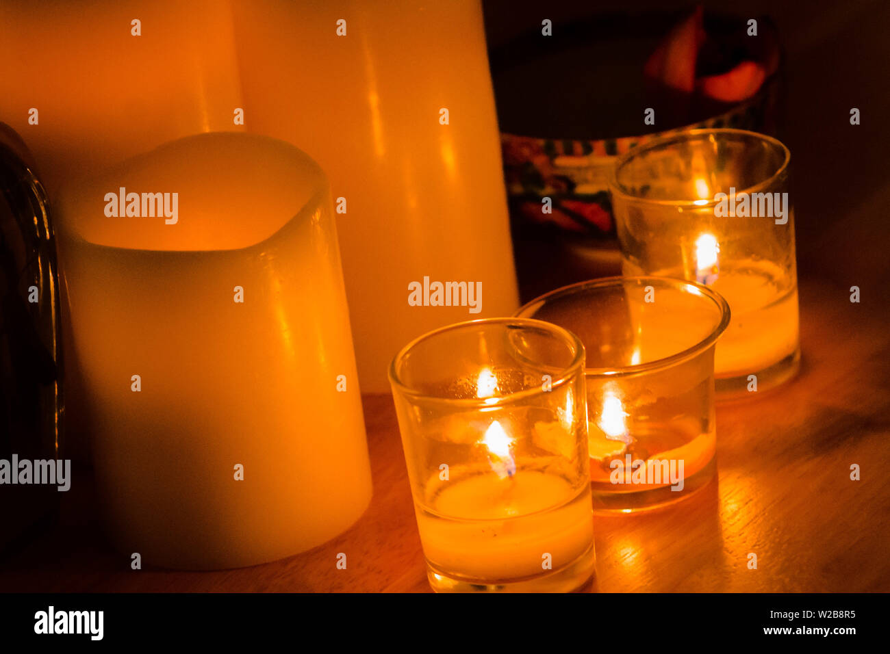 Lit candles warming up a dark room Stock Photo - Alamy
