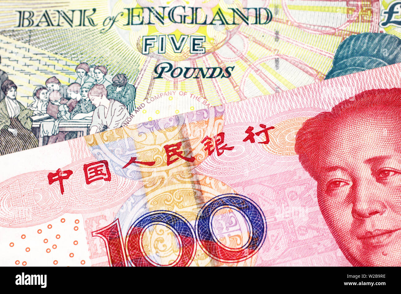 A Five Pound British Pound Sterling With A Red One Hundred Yuan a-five-pound-british-pound-sterling-with-a-red-one-hundred-yuan