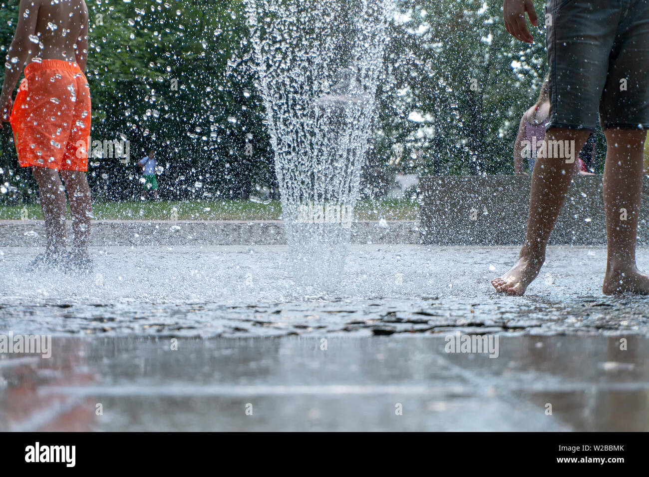 Run through water sprinkler hi-res stock photography and images - Alamy
