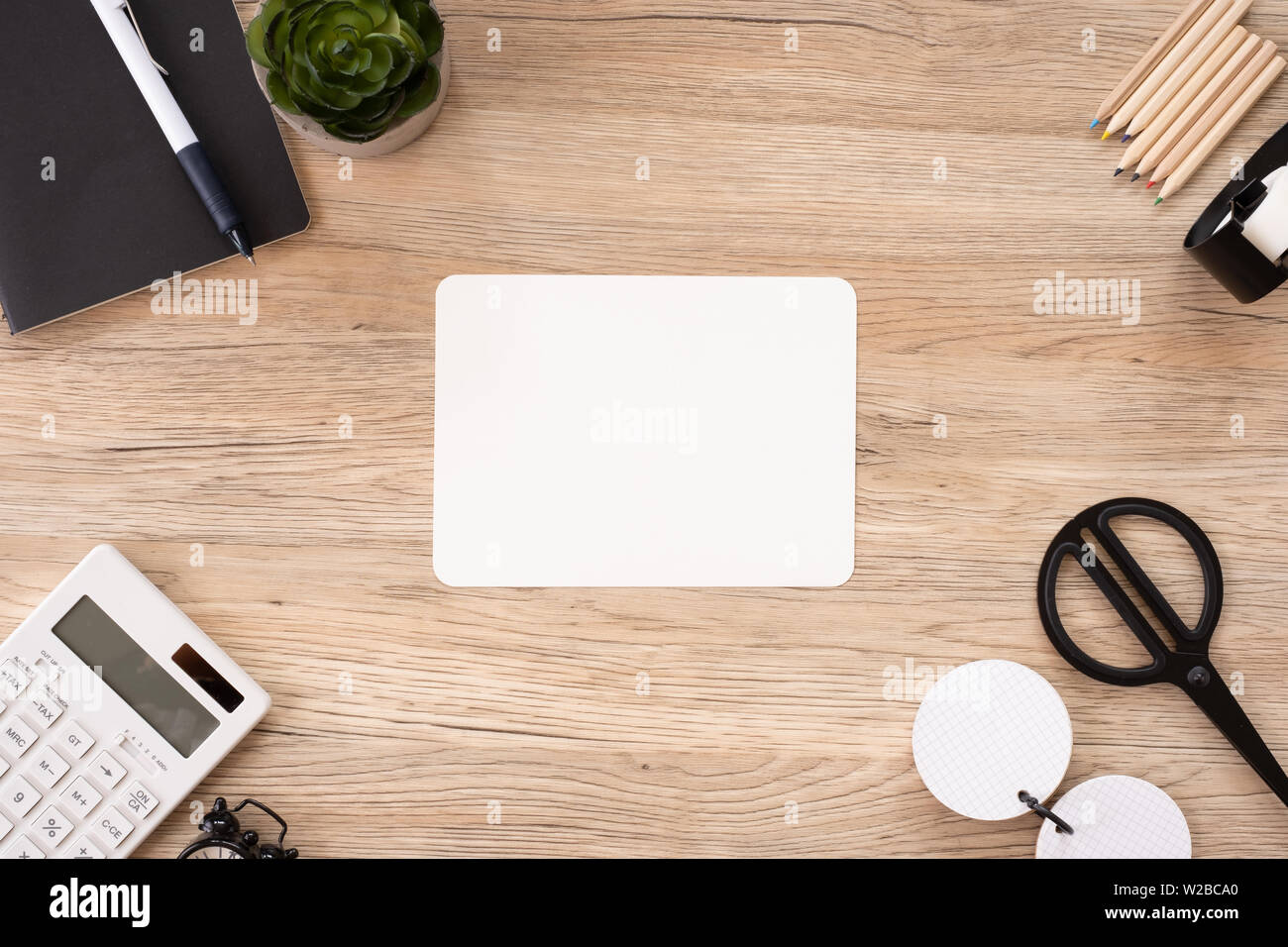 top view blank white paper note with office stationery on wooden table ...