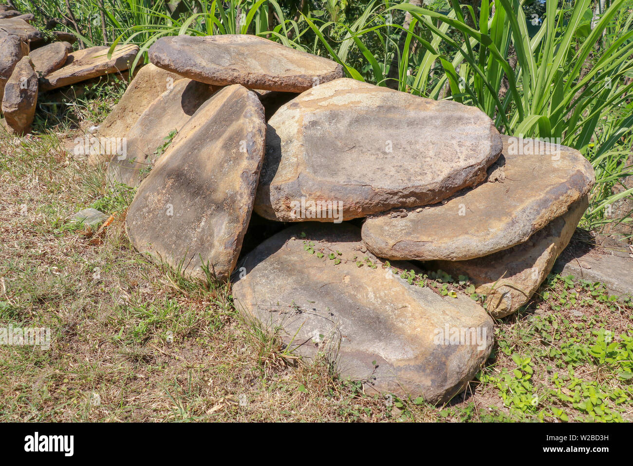 Big flat stones of yellow color. Natural building material. Boulders ...