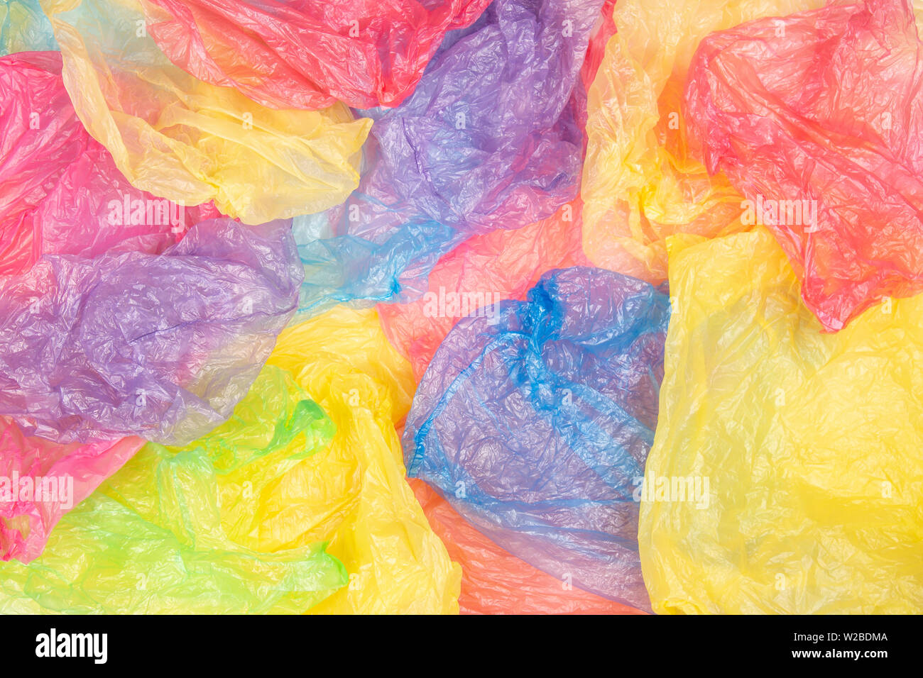 Multicolored single use plastic shopping bags background Stock Photo ...
