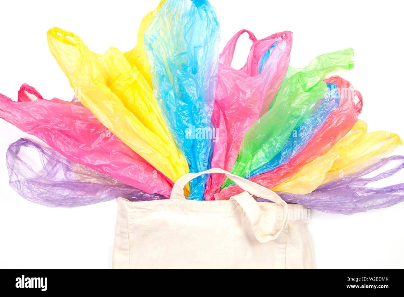 Many single use plastic bags in one eco natural reusable shopping bag ...