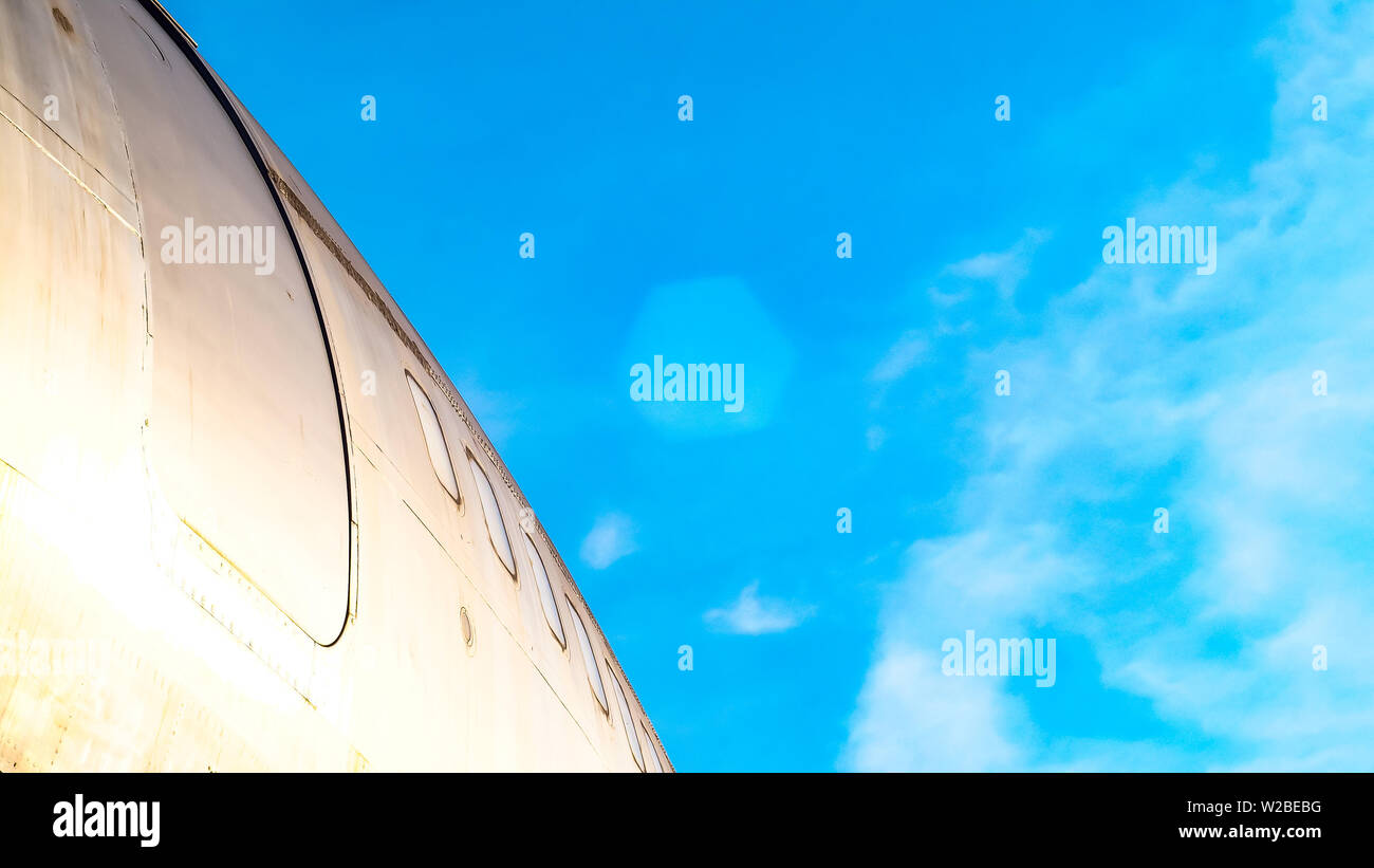 modern airplane parked on airport runway isolated on blue sky ...