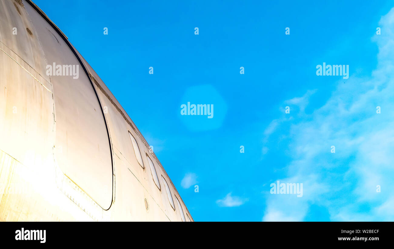modern airplane parked on airport runway isolated on blue sky ...