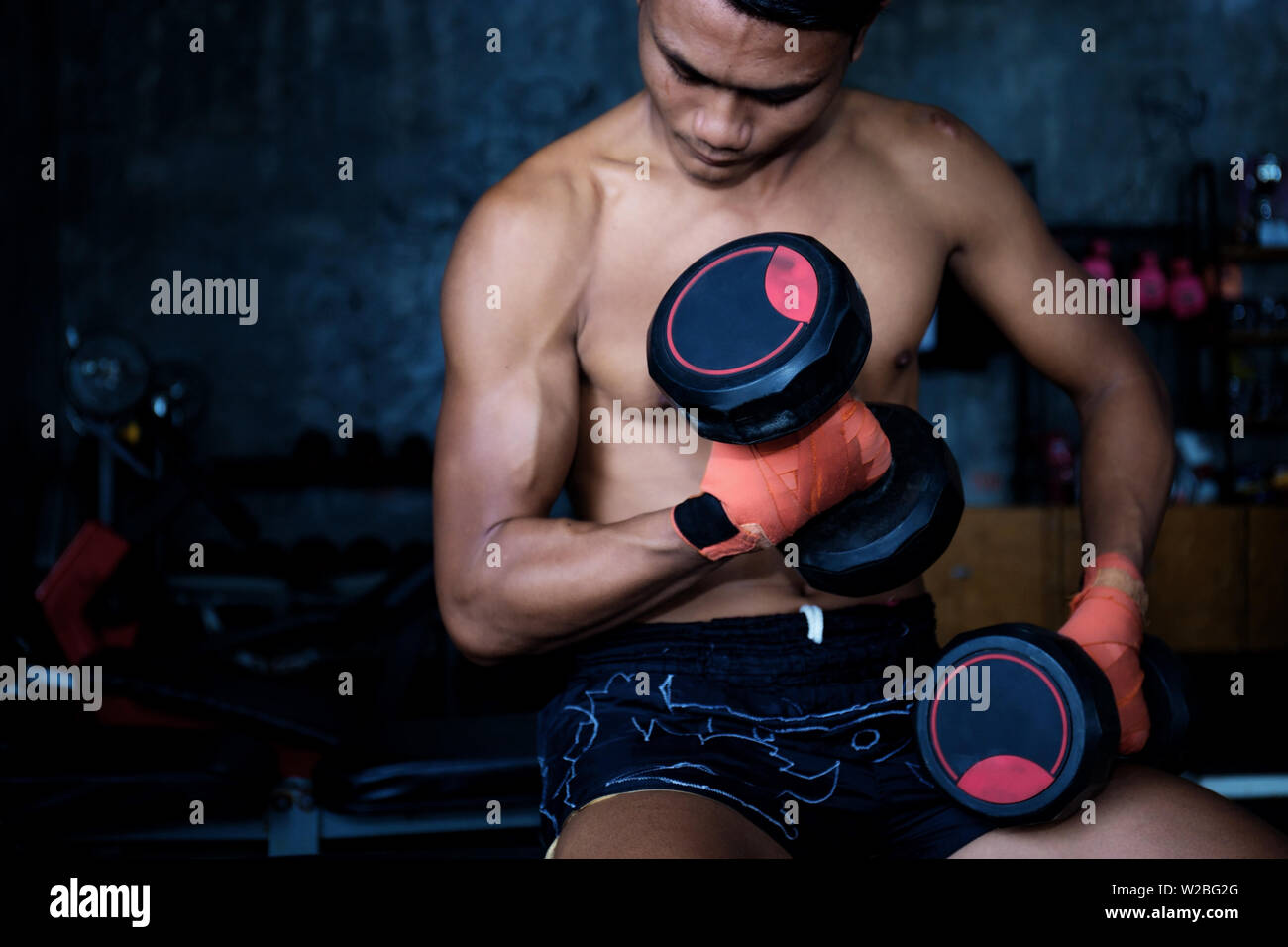 Asian men working out exercises with dumbbells in gym Stock Photo - Alamy