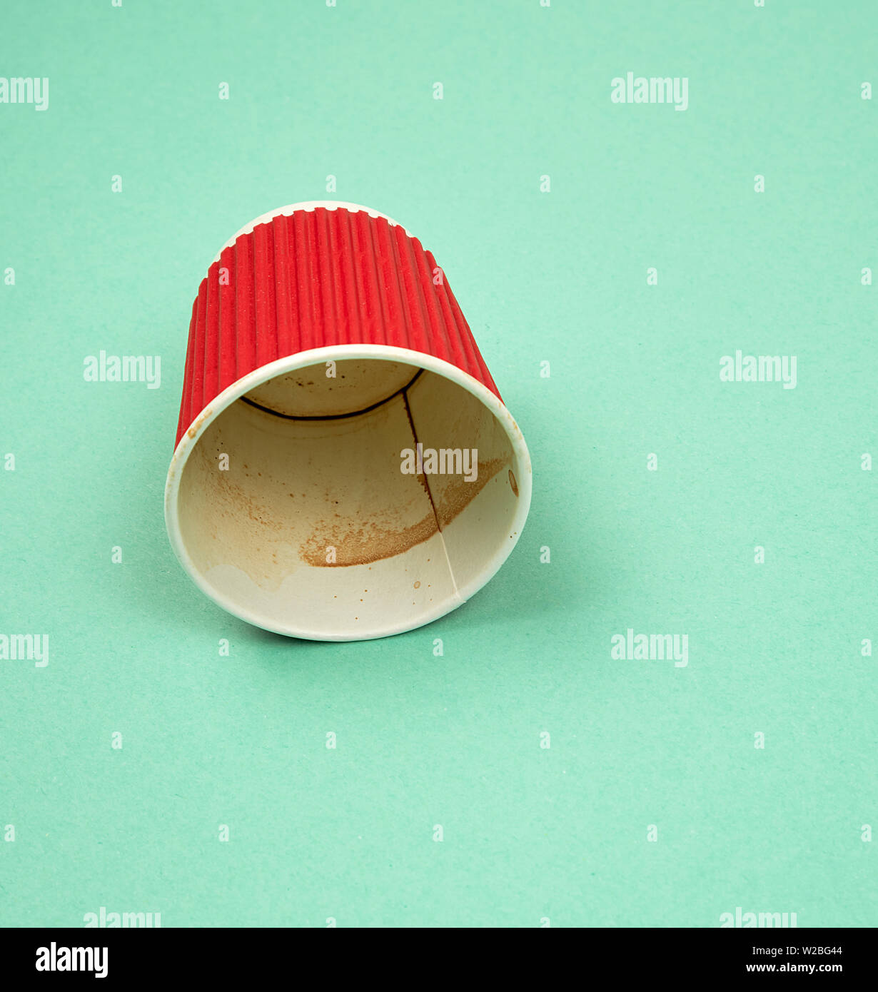 red paper cup with corrugated edges for hot drinks on a green ...