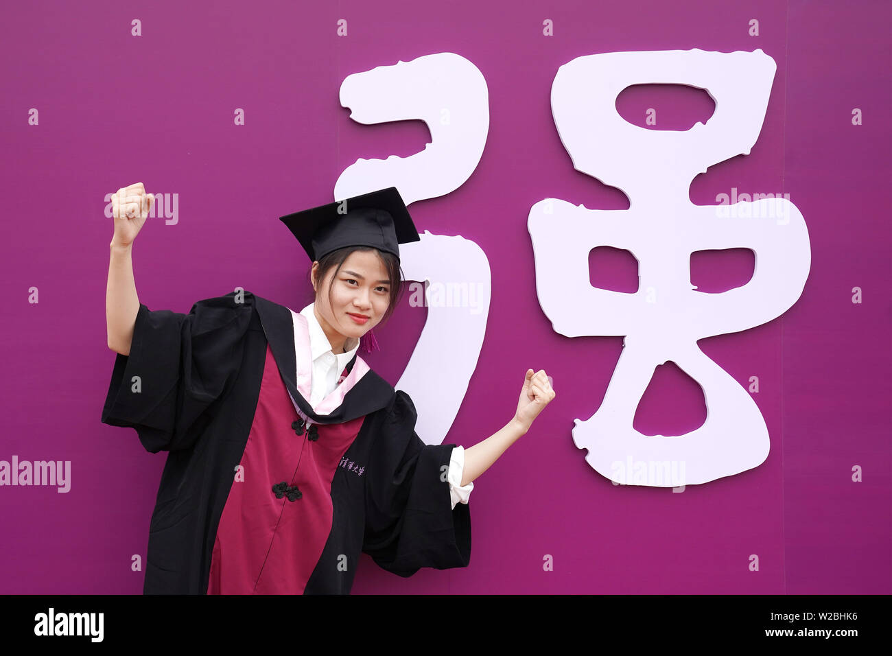 Beijing, China. 7th July, 2019. A graduate poses for photos during the ...