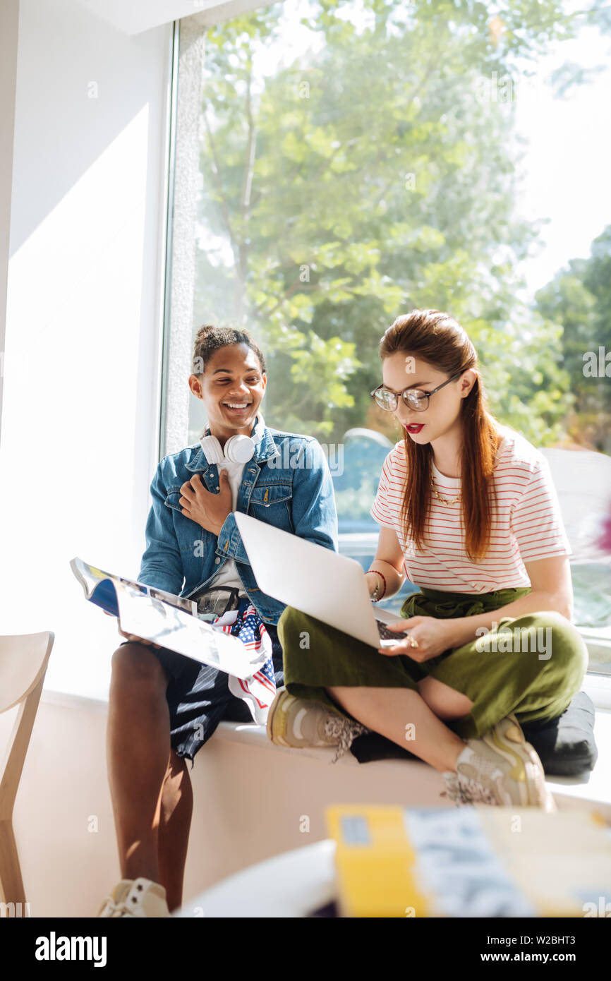 Sincere communication. Happy international man laughing while talking ...