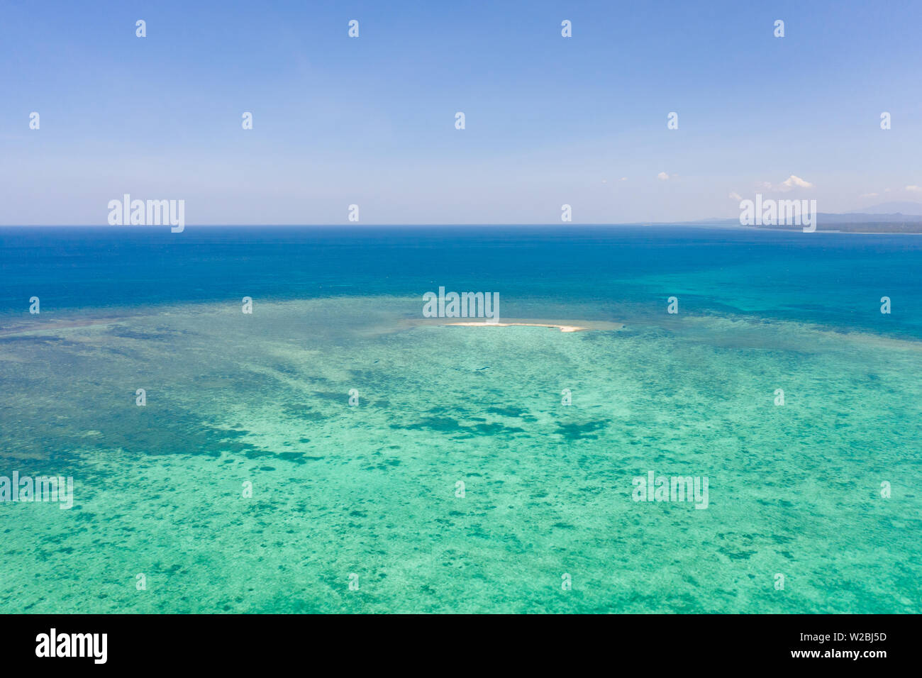 Sandbar on a coral reef. Atoll with a small sandy island. Seascape in ...