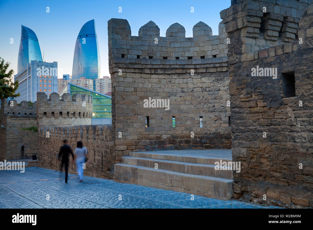 Azerbaijan, Baku, View of Old City walls and the Flame Towers at night ...
