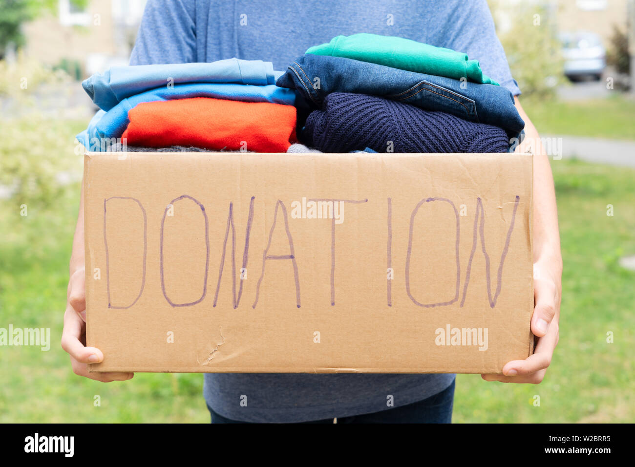 Clothing donation container and person hi-res stock photography and ...