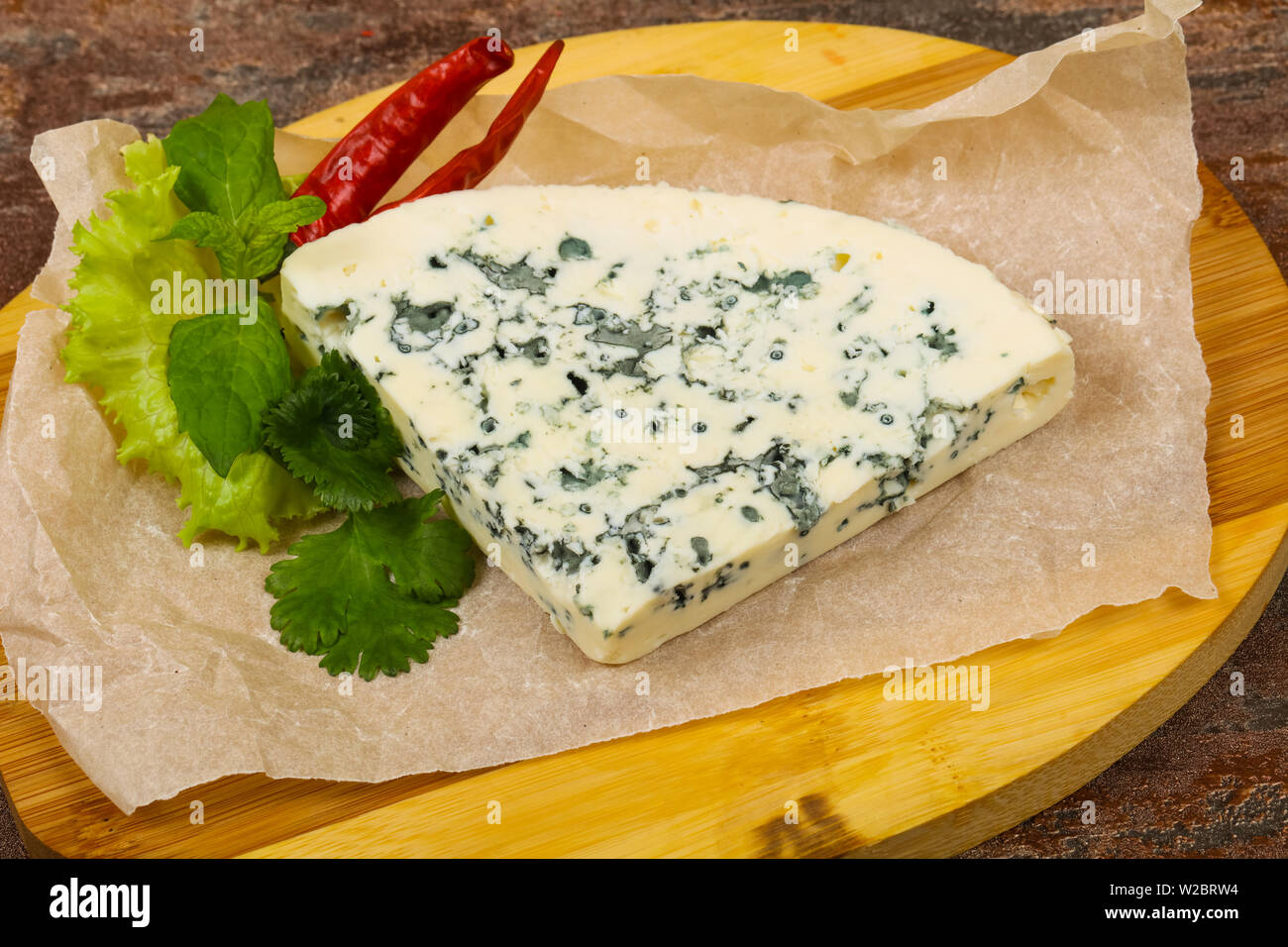 Blue cheese slice with salad leaves Stock Photo - Alamy