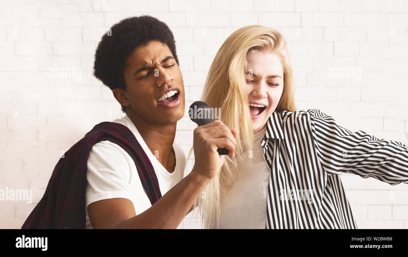 Happy diverse friends singing together at home Stock Photo - Alamy