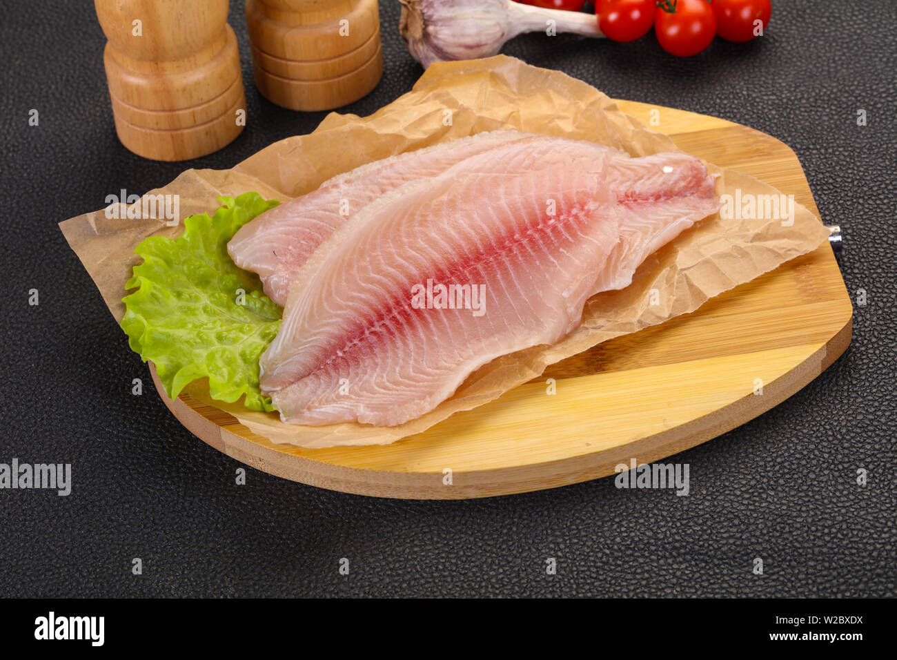 Raw tilapia fish ready for cooking Stock Photo - Alamy