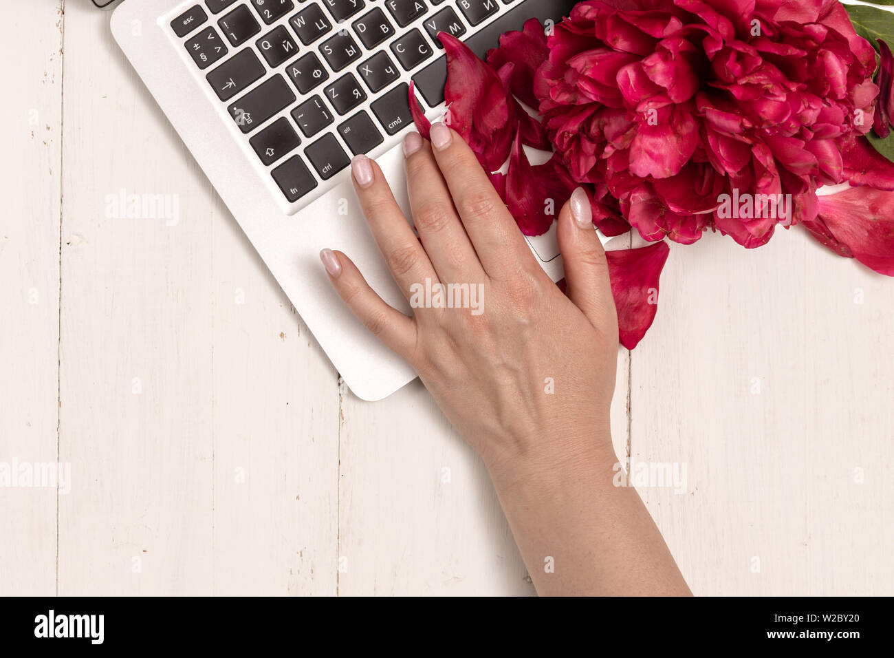 Workspace with girl's hand on laptop keyboard Stock Photo - Alamy