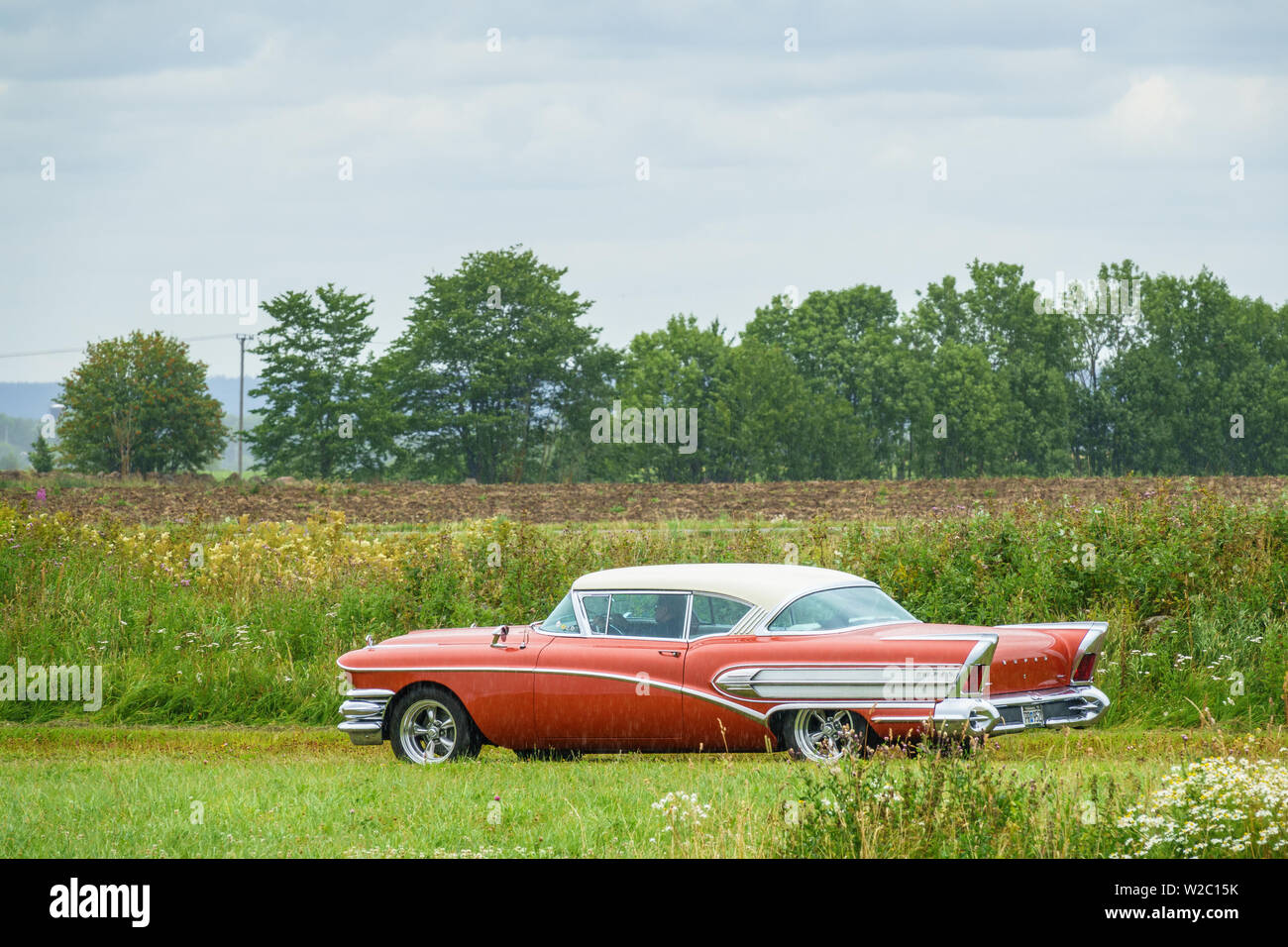 Old American vintage car driving in the rain at countryside Stock Photo ...