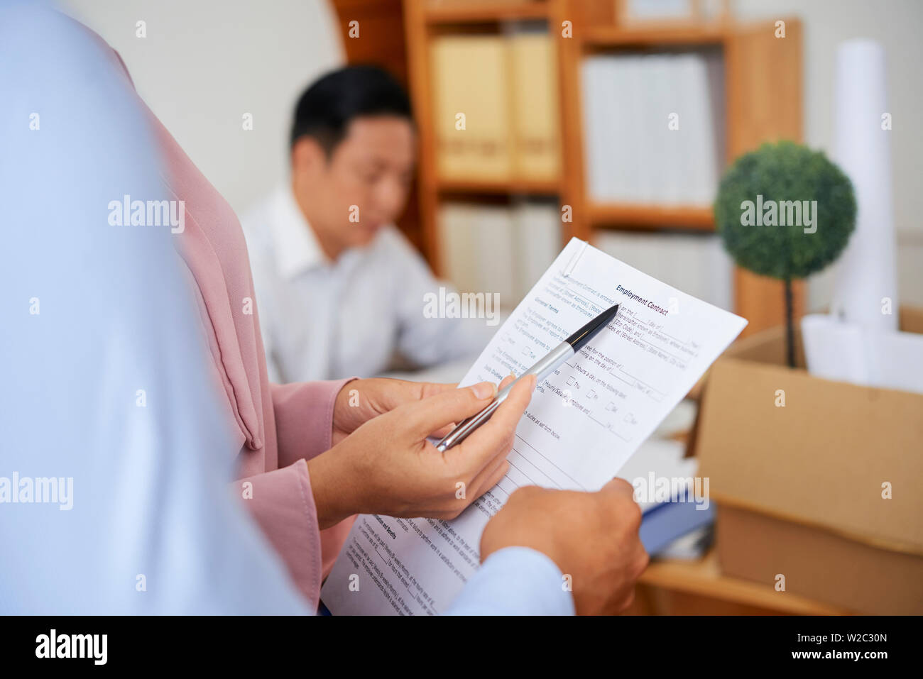 Hands of businesswoman explaining employment contract details to ...