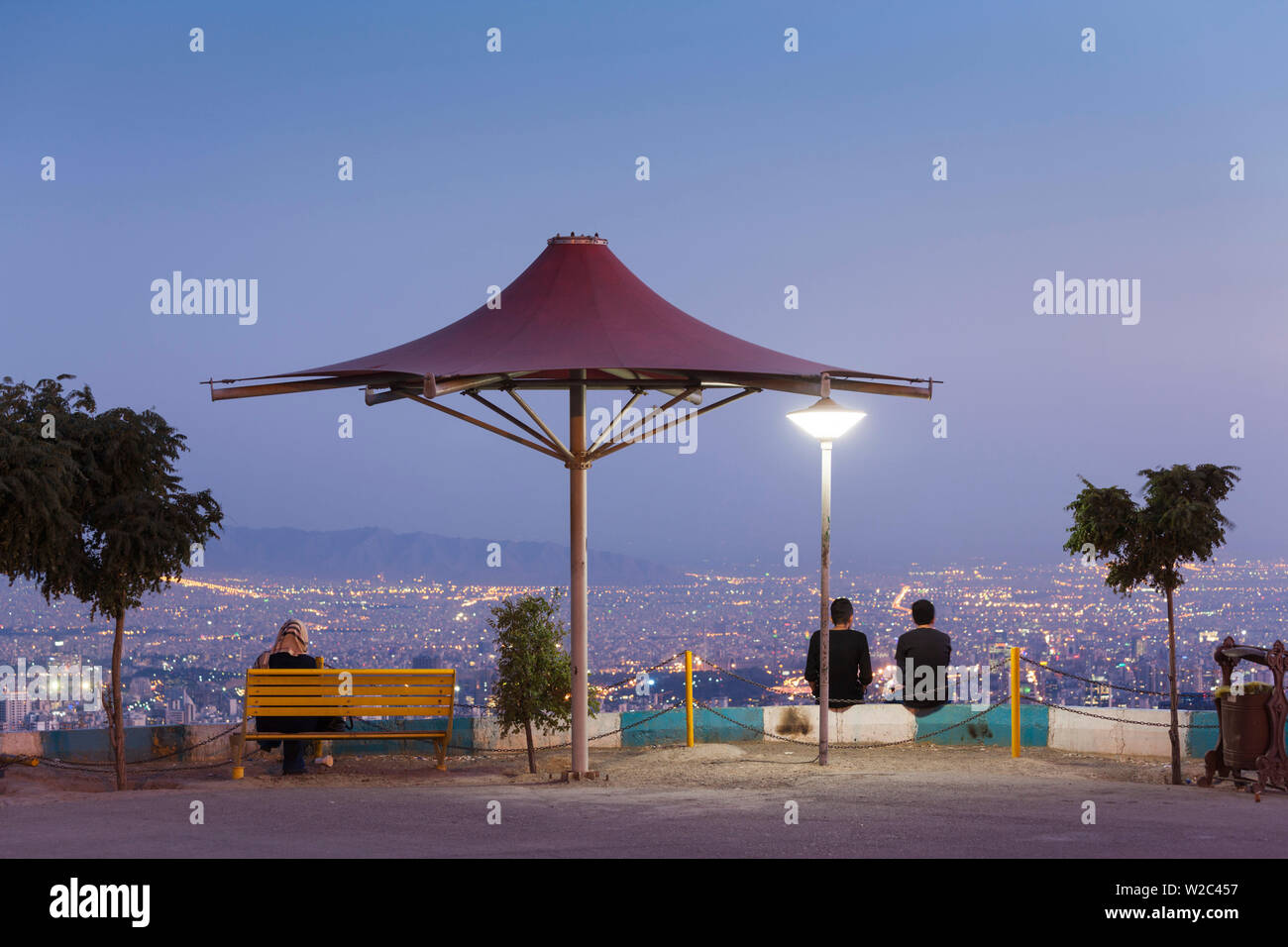 Iran, Tehran, visitors to the Roof of Iran Park above the city skyline ...