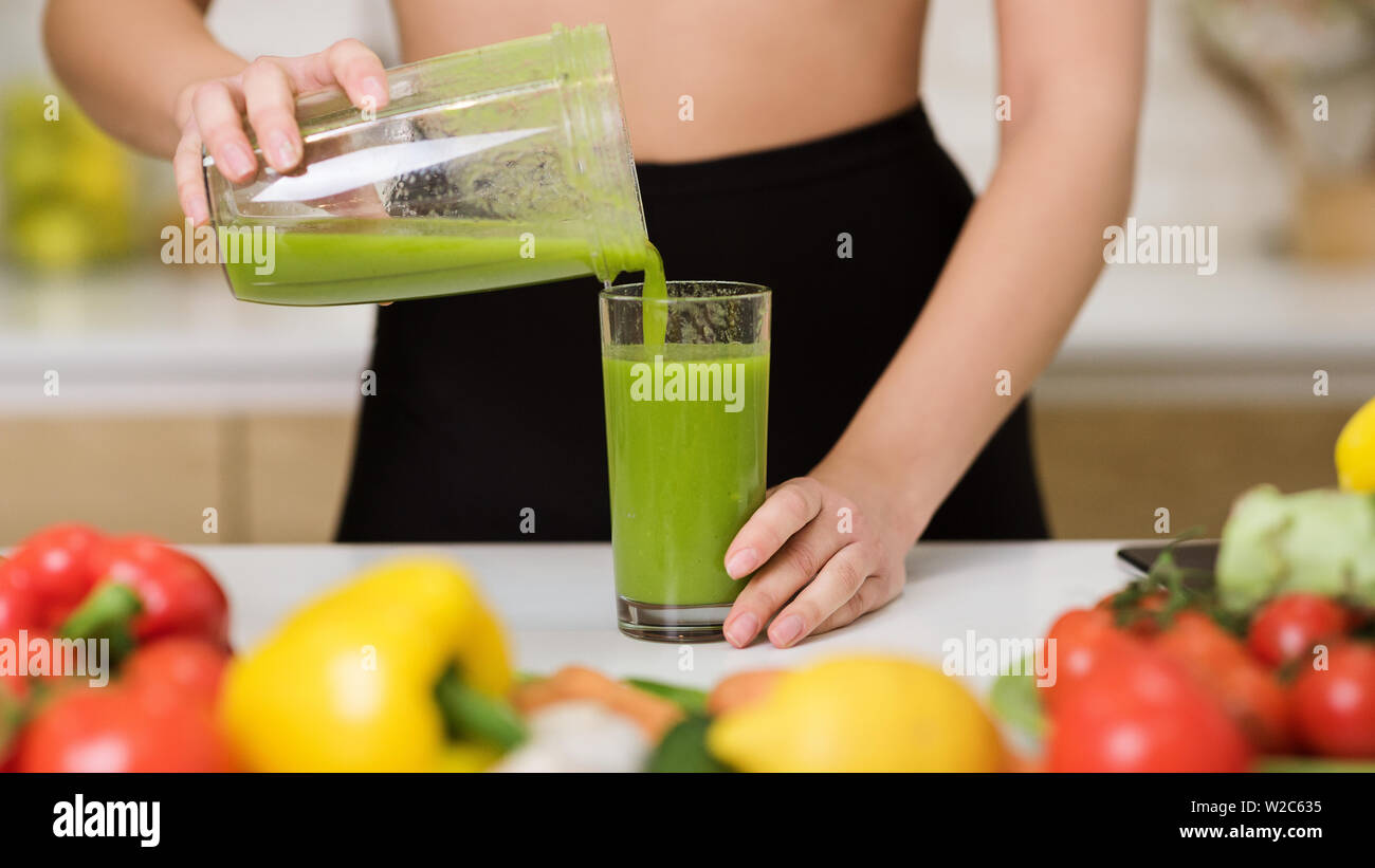 Healthy eating. Woman pouring detox shake to glass Stock Photo - Alamy