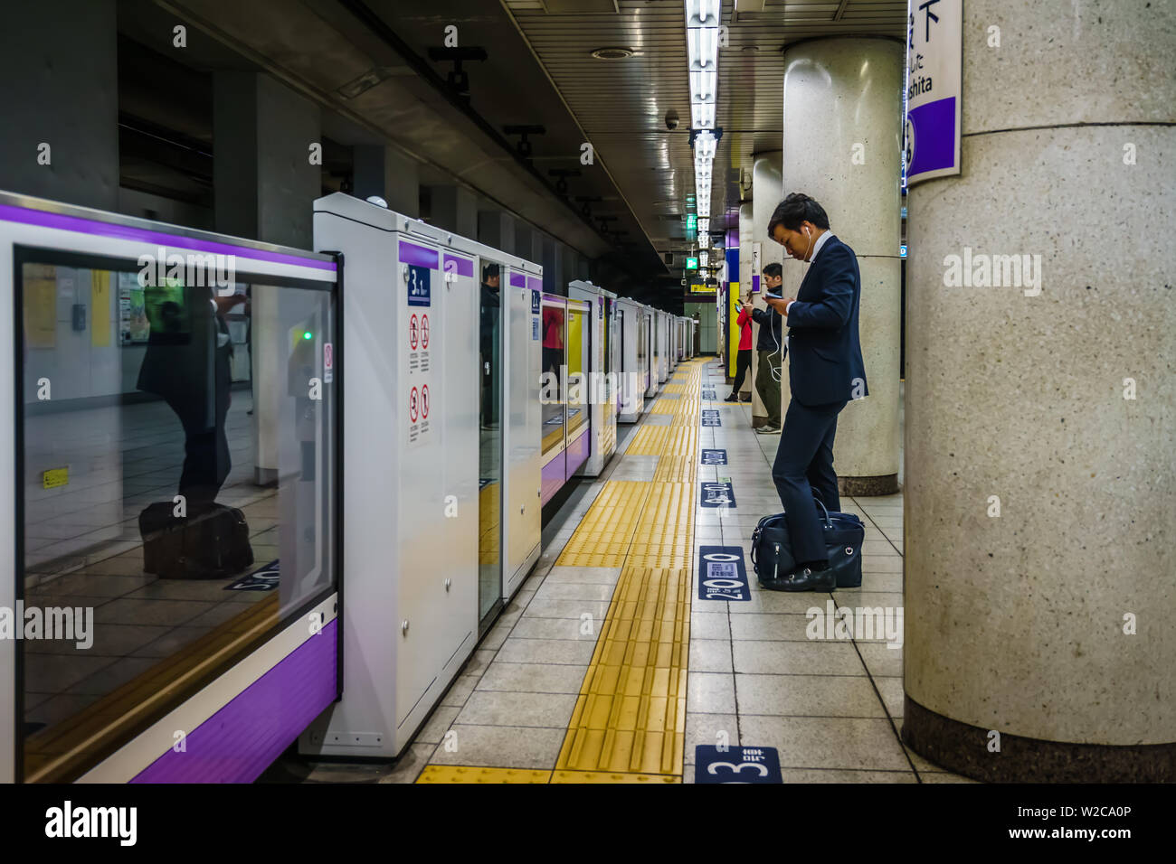 Tokyo, Japan - May 8, 2019: Commuters waiting at subway station for ...