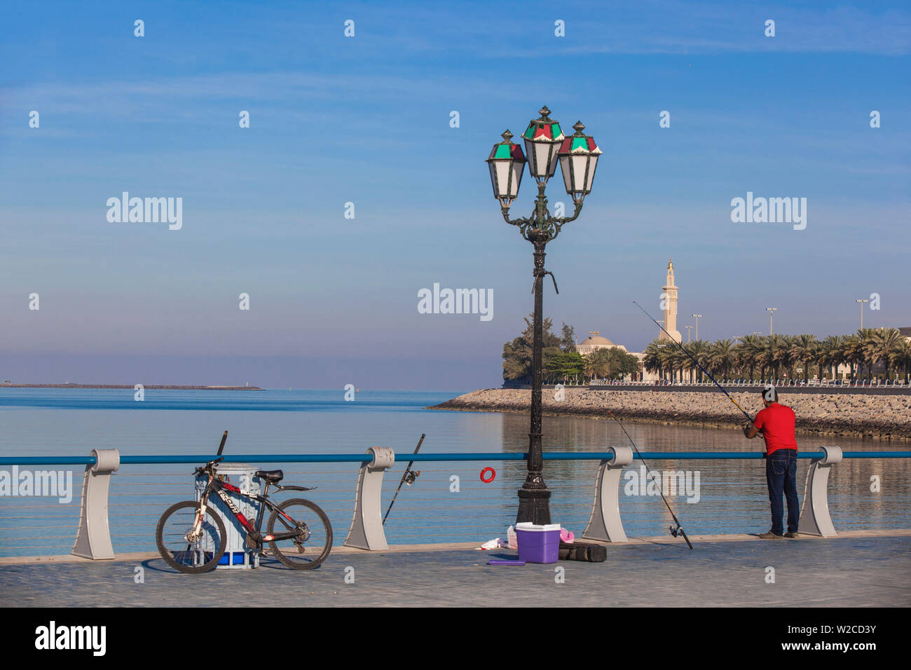 United Arab Emirates, Abu Dhabi, Man fishing on the Corniche breakwater ...