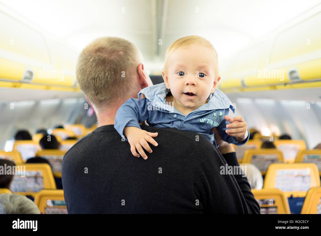 Father with his six old baby boy in the airplane hi-res stock ...