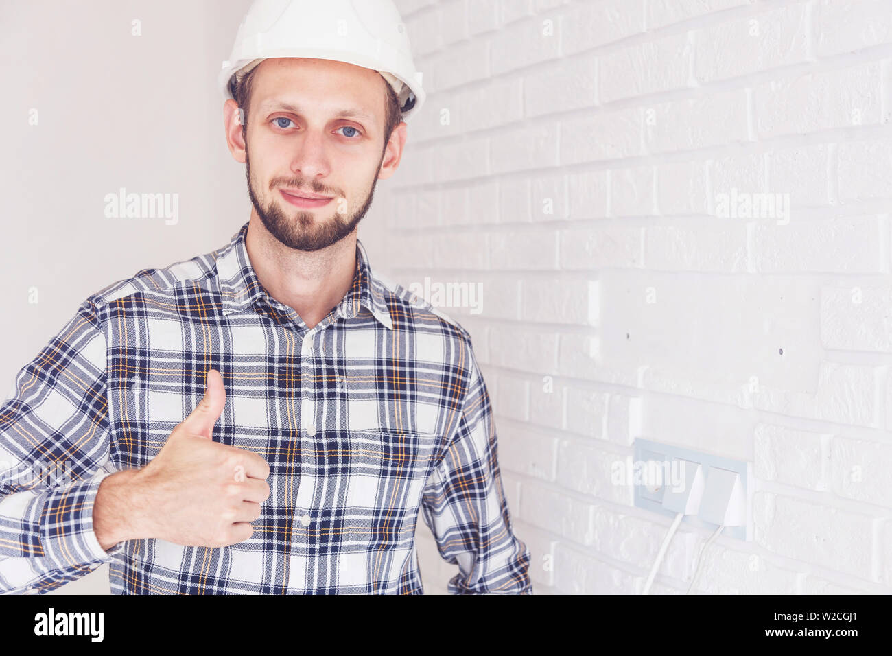 Engineer With Thumb Up Sign in white interior Stock Photo - Alamy