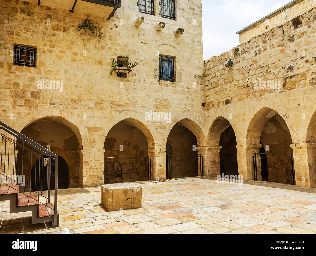 A small courtyard with arches in the walls of ancient Jerusalem Israel ...