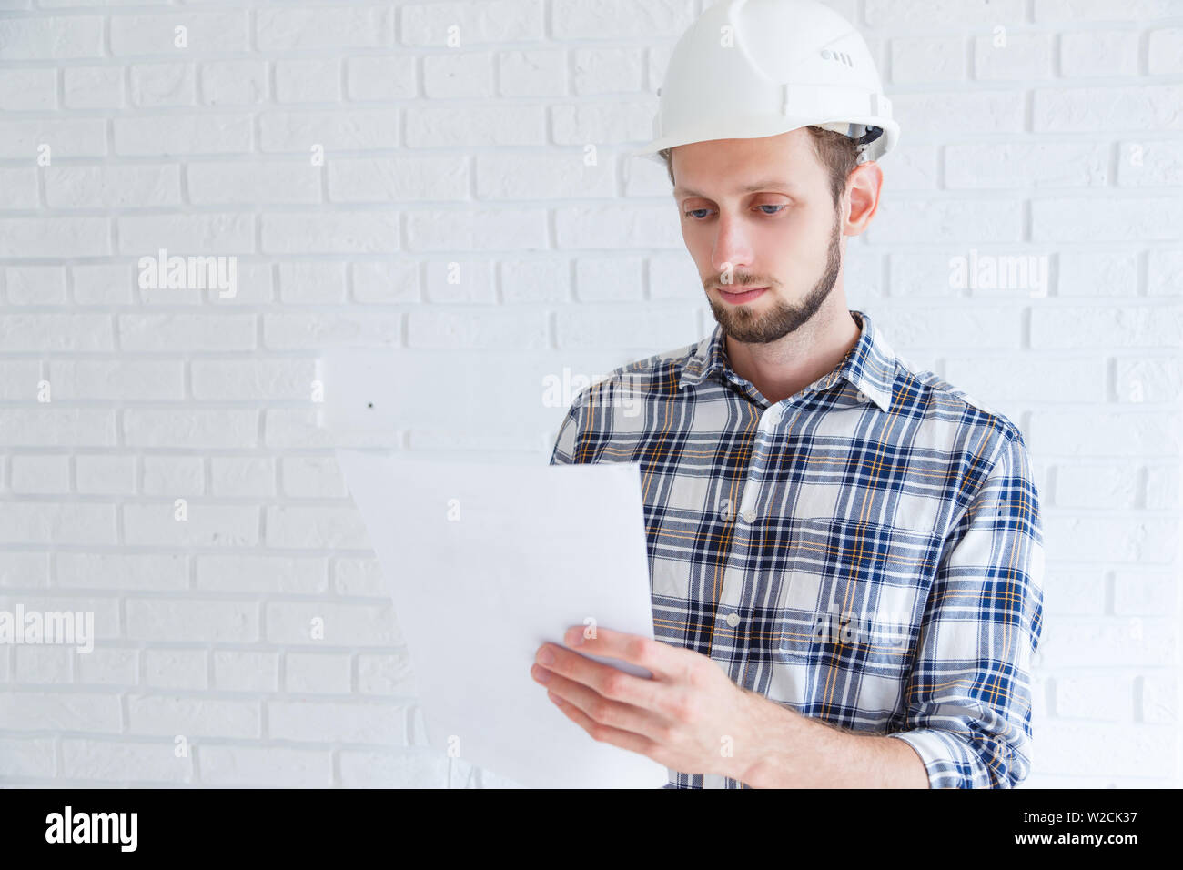 Construction renovation engineer reading documents Stock Photo - Alamy