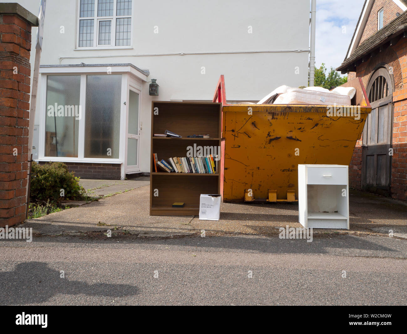 Giving away unwanted goods in front of house drive way Stock Photo - Alamy