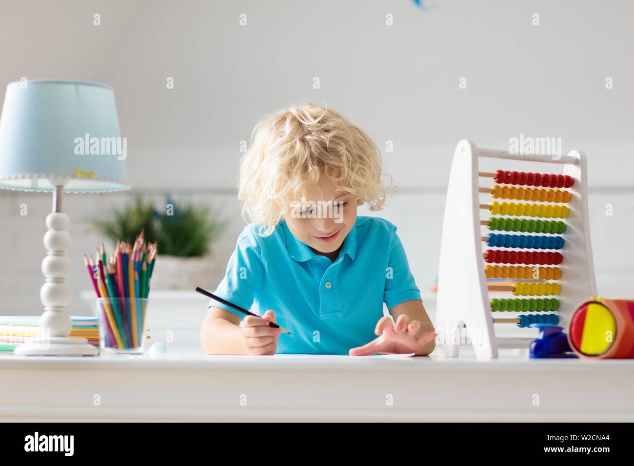 Child doing homework at home. Little boy with wooden colorful abacus ...