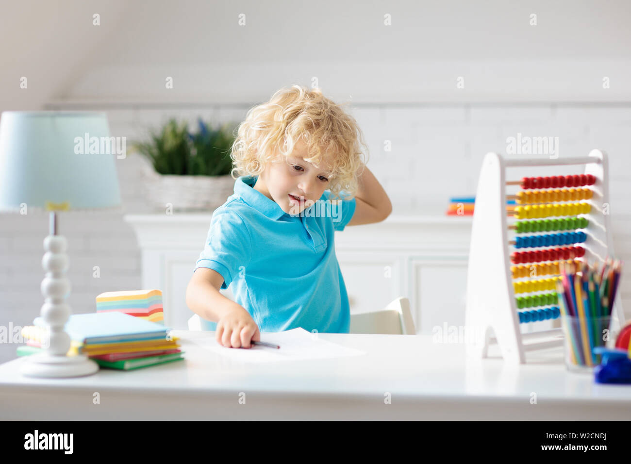 Child doing homework at home. Little boy with wooden colorful abacus ...